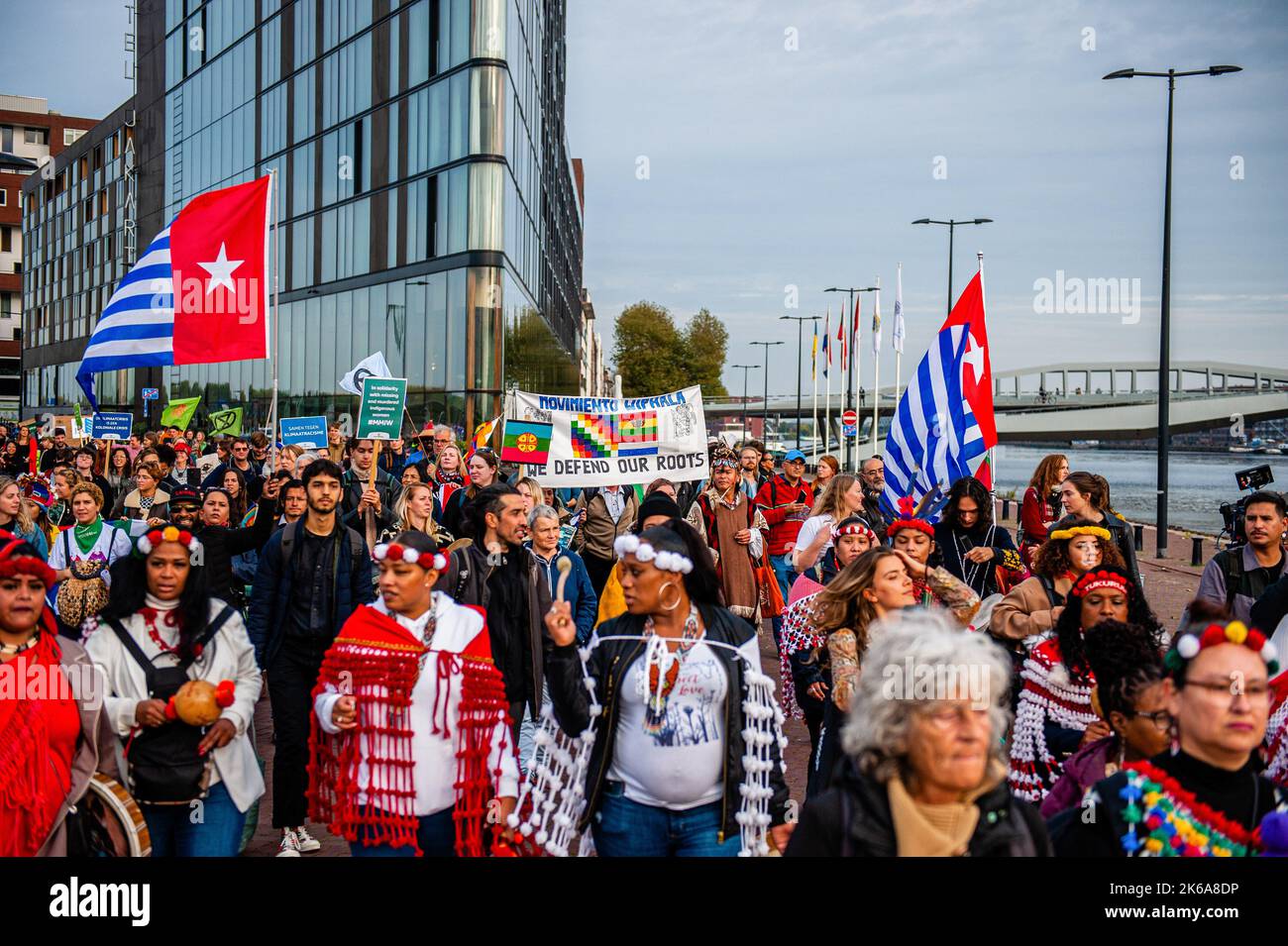 Indigenous people and their supporters wearing traditional clothes hold ...