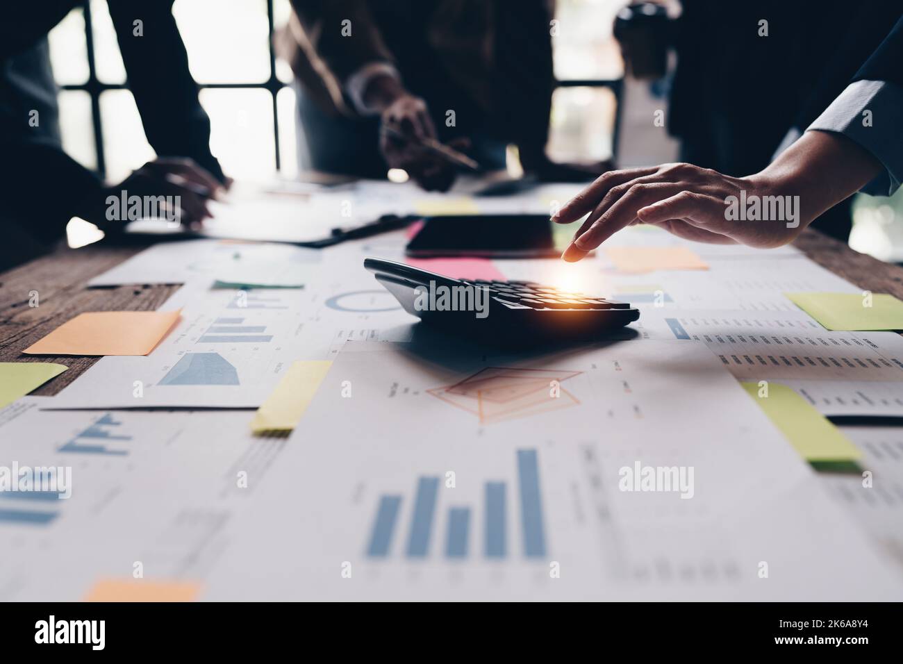 Asian Business Woman or Accountant do math and analyze with calculator ...