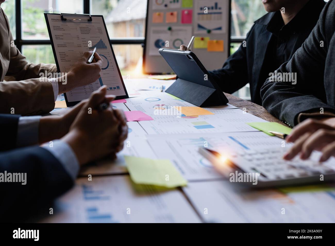 Asian Business people or Accountant do math and analyze with calculator ...