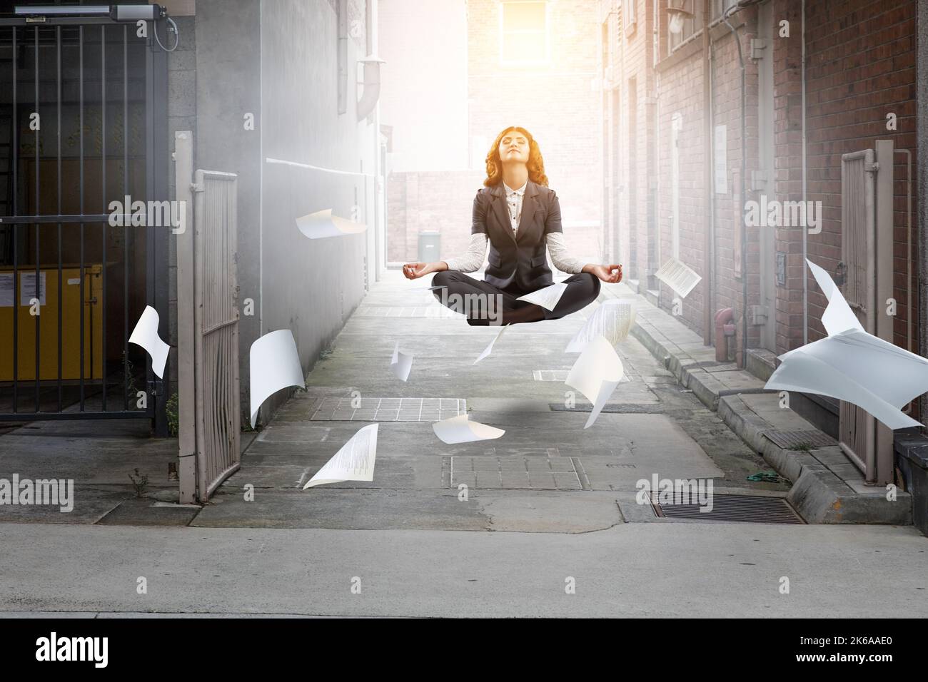 Beautiful businesswoman meditating . Mixed media Stock Photo - Alamy