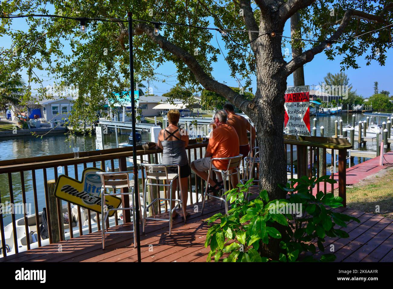 People enjoying the canal views of boats & piers while outdoor drinking ...