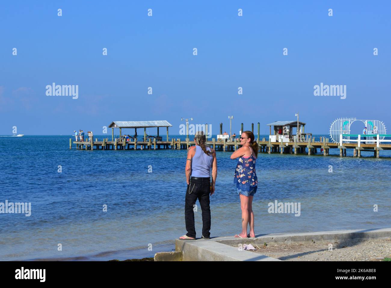 A couple views the wooden Bokeelia Fishing Pier on the northern tip of ...