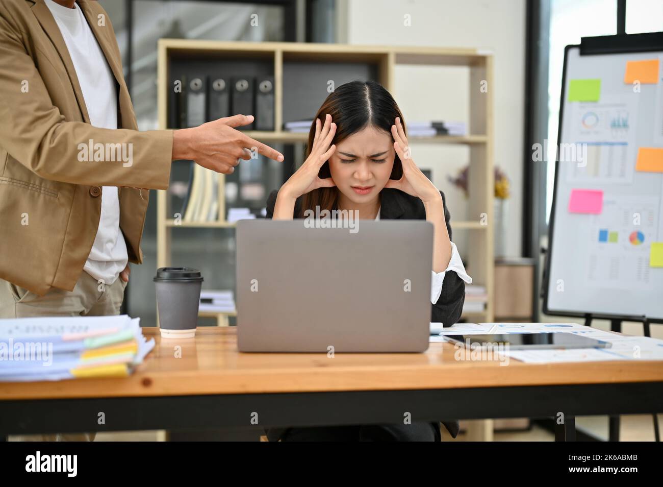 Stressed young Asian female office employee getting complaint by her ...