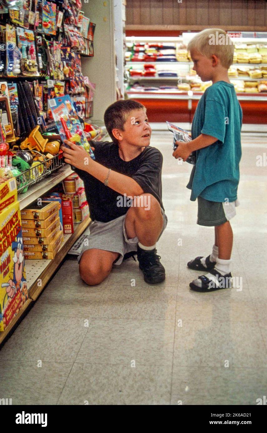 While shopping in a supermarket in Riverside, CA, a boy explains an ...