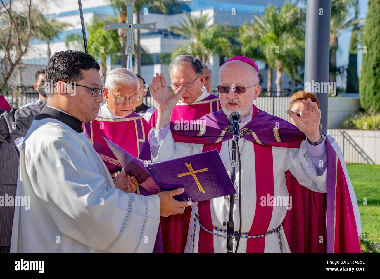 A bishop conducts a ceremonial blessing of a cemetery at a Garden Grove ...