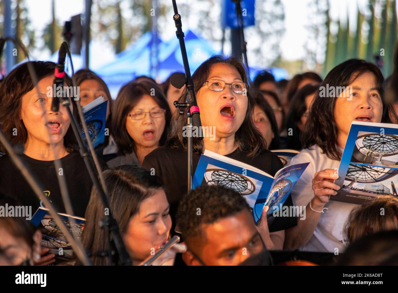Multiracial female choir members rehearse for a religious ceremony at a ...