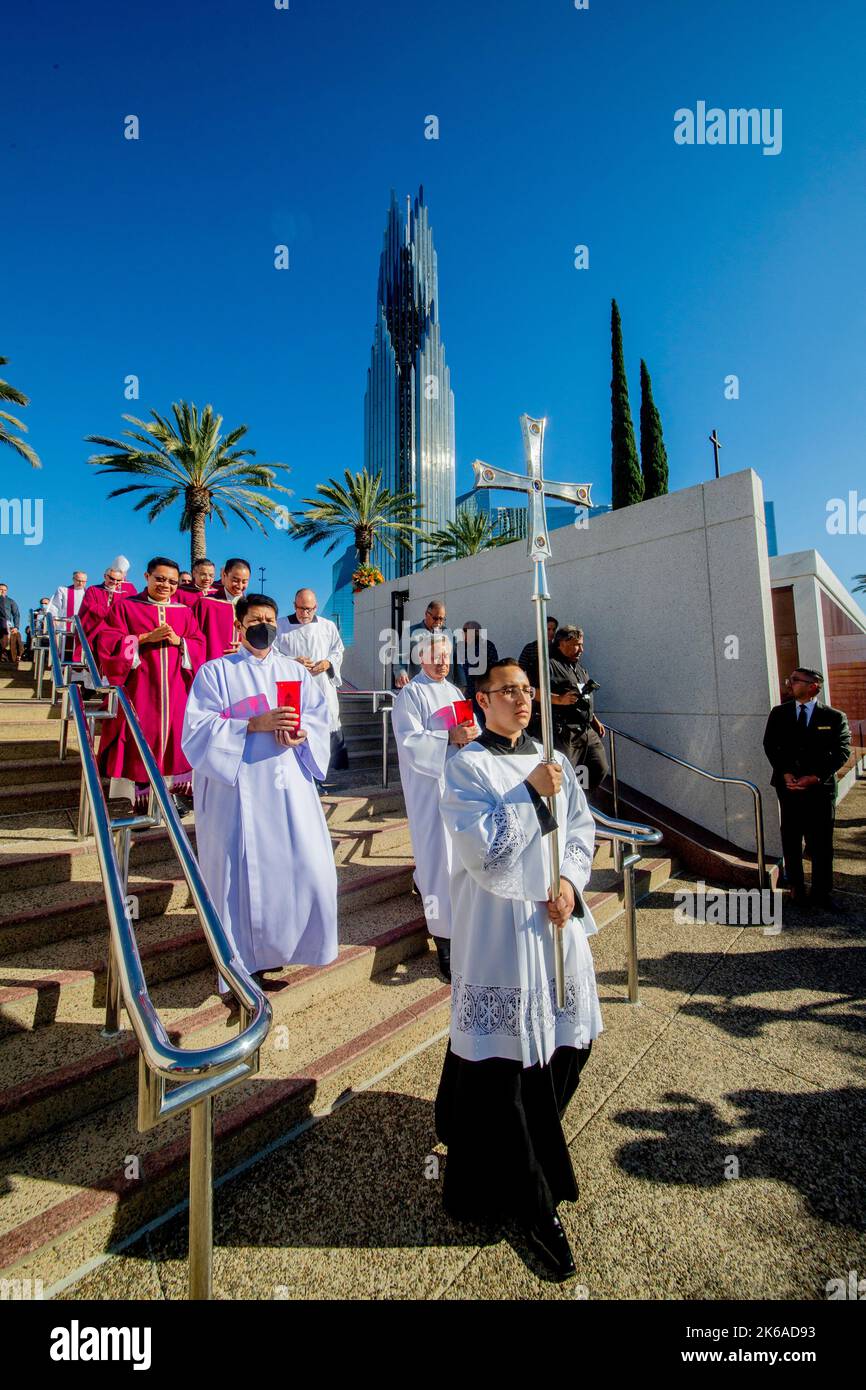 Lead by a cross, a multiracial religious procession marches to a ...