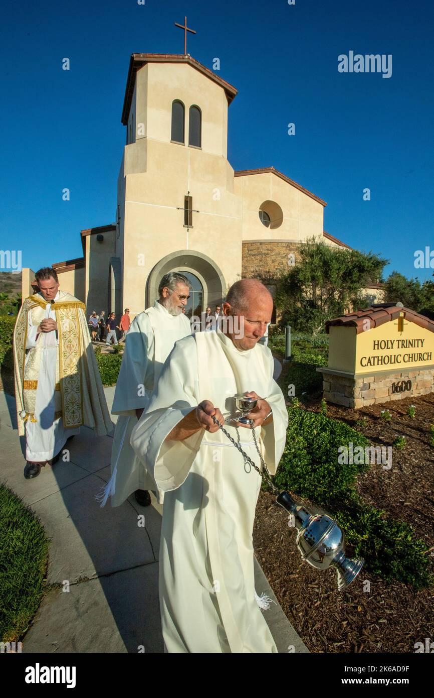 Accompanied by deacons, the priest of a Southern California Catholic ...