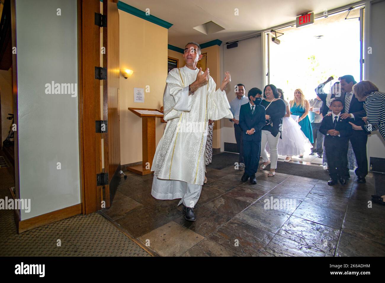 At the door of a Southern California Catholic church, the robed ...