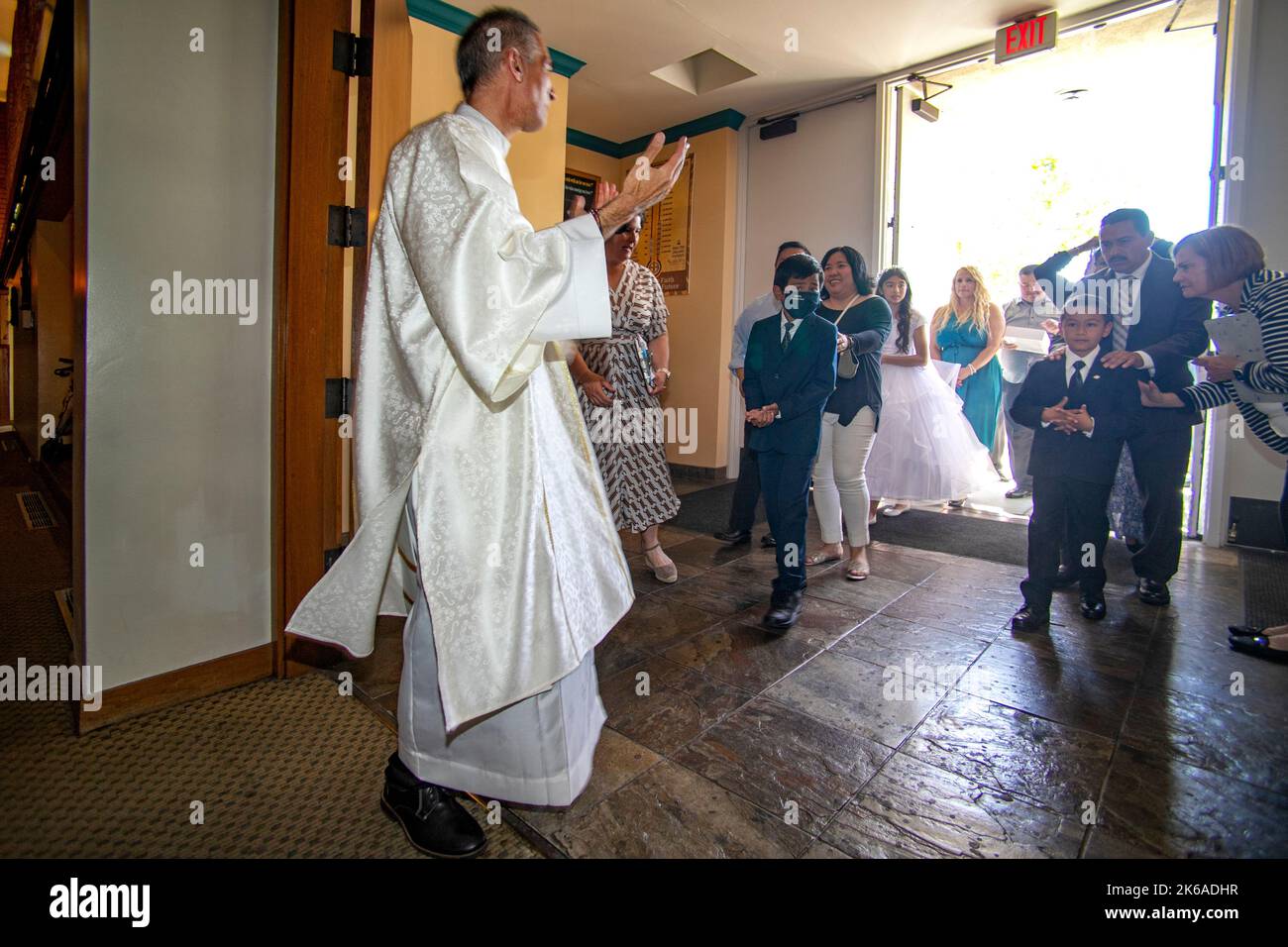 At the door of a Southern California Catholic church, the robed ...