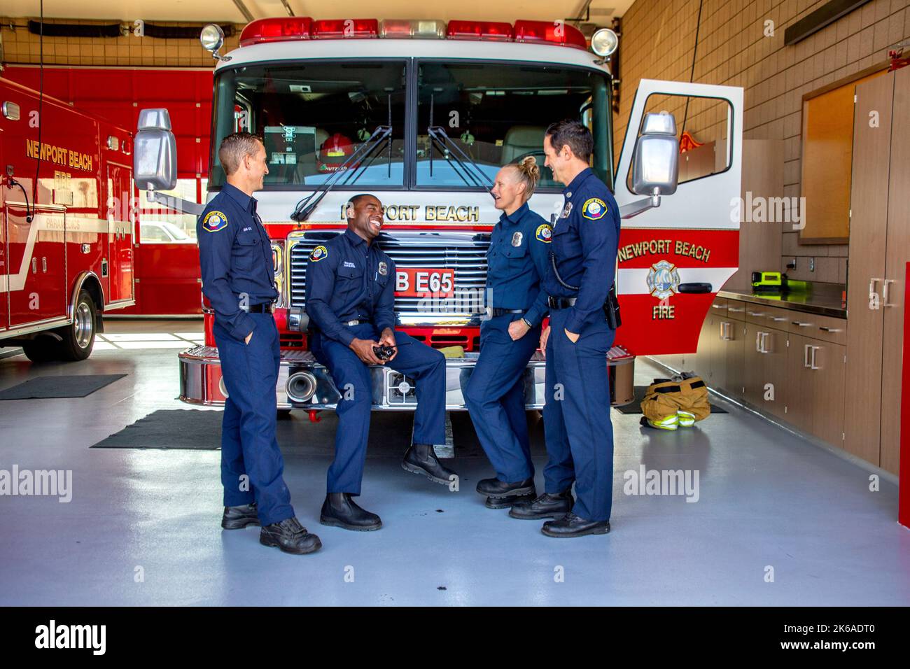 Four firemen converse in front of a fire truck in Newport Beach, CA ...