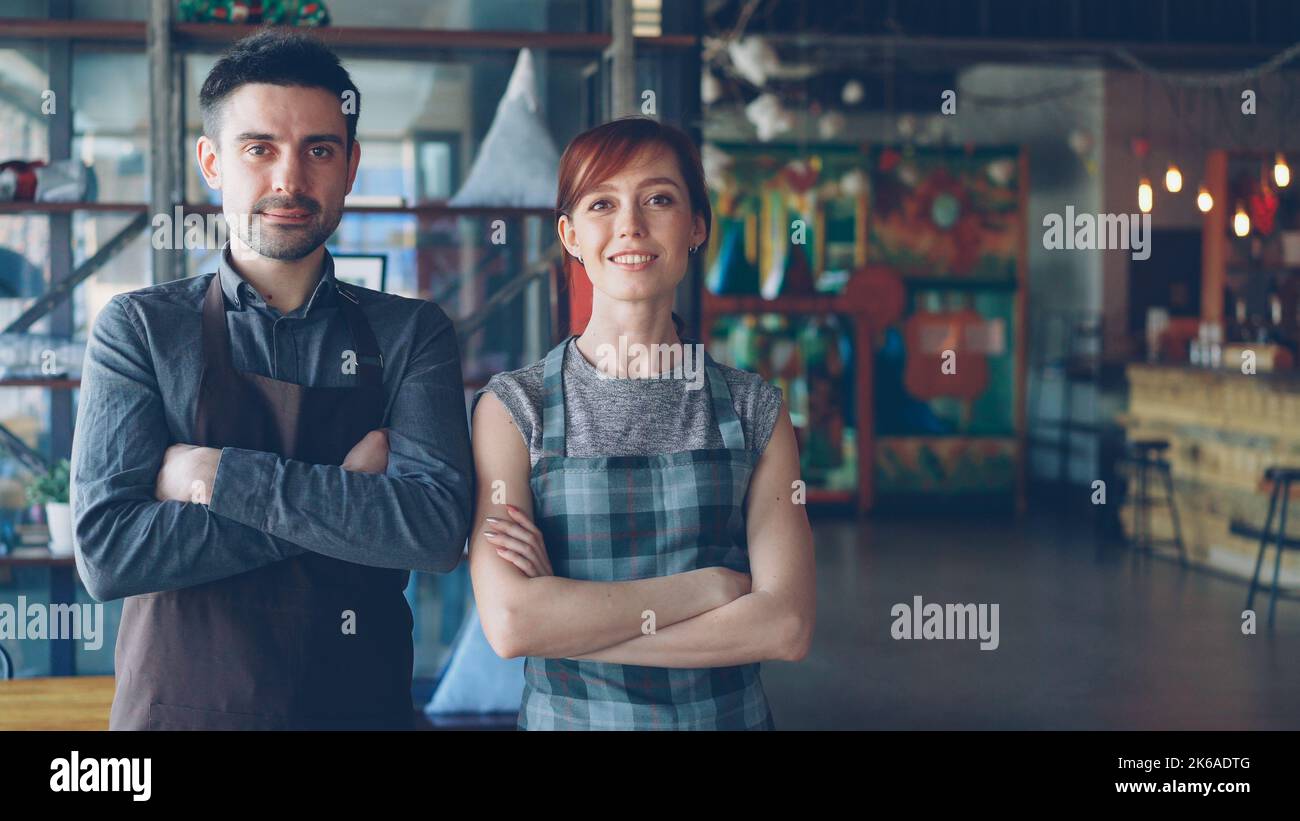 Portrait of two proud small business owners standing together inside ...