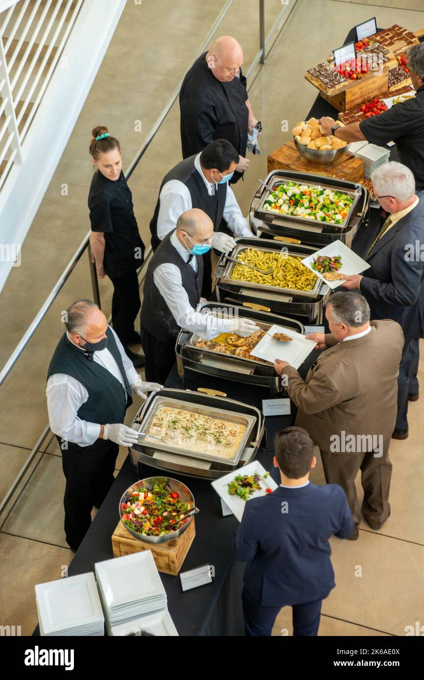 Diners line up at a gourmet dinner buffet serving line in Southern ...