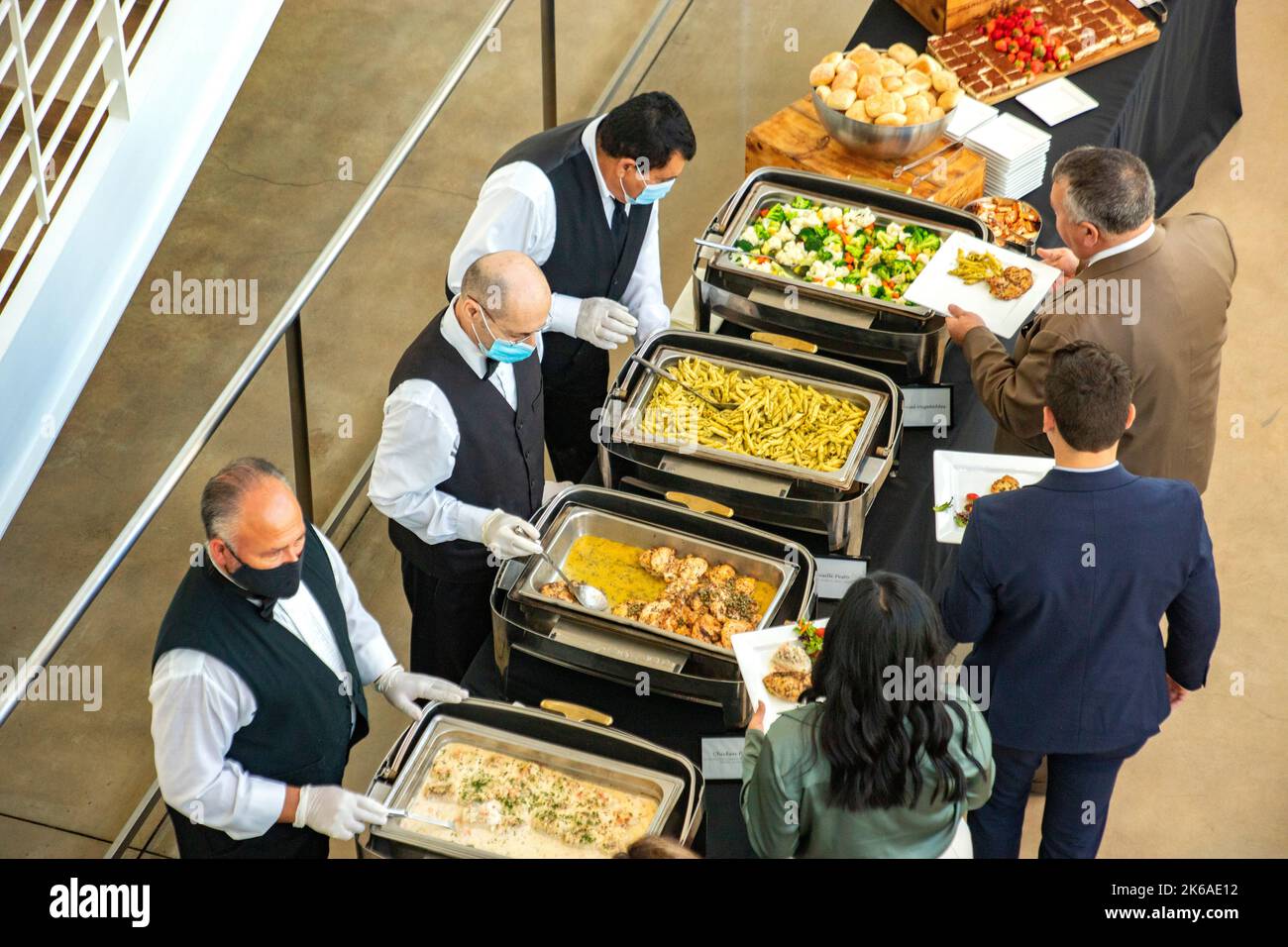 Diners line up at a gourmet dinner buffet serving line in Southern ...