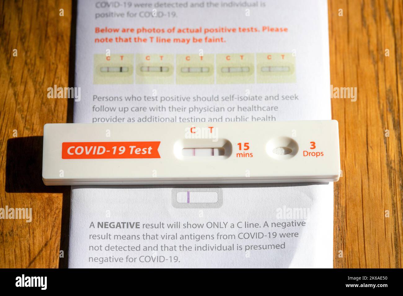 Two lines on a COVI9-19 rapid test indicate a positive result and the ...
