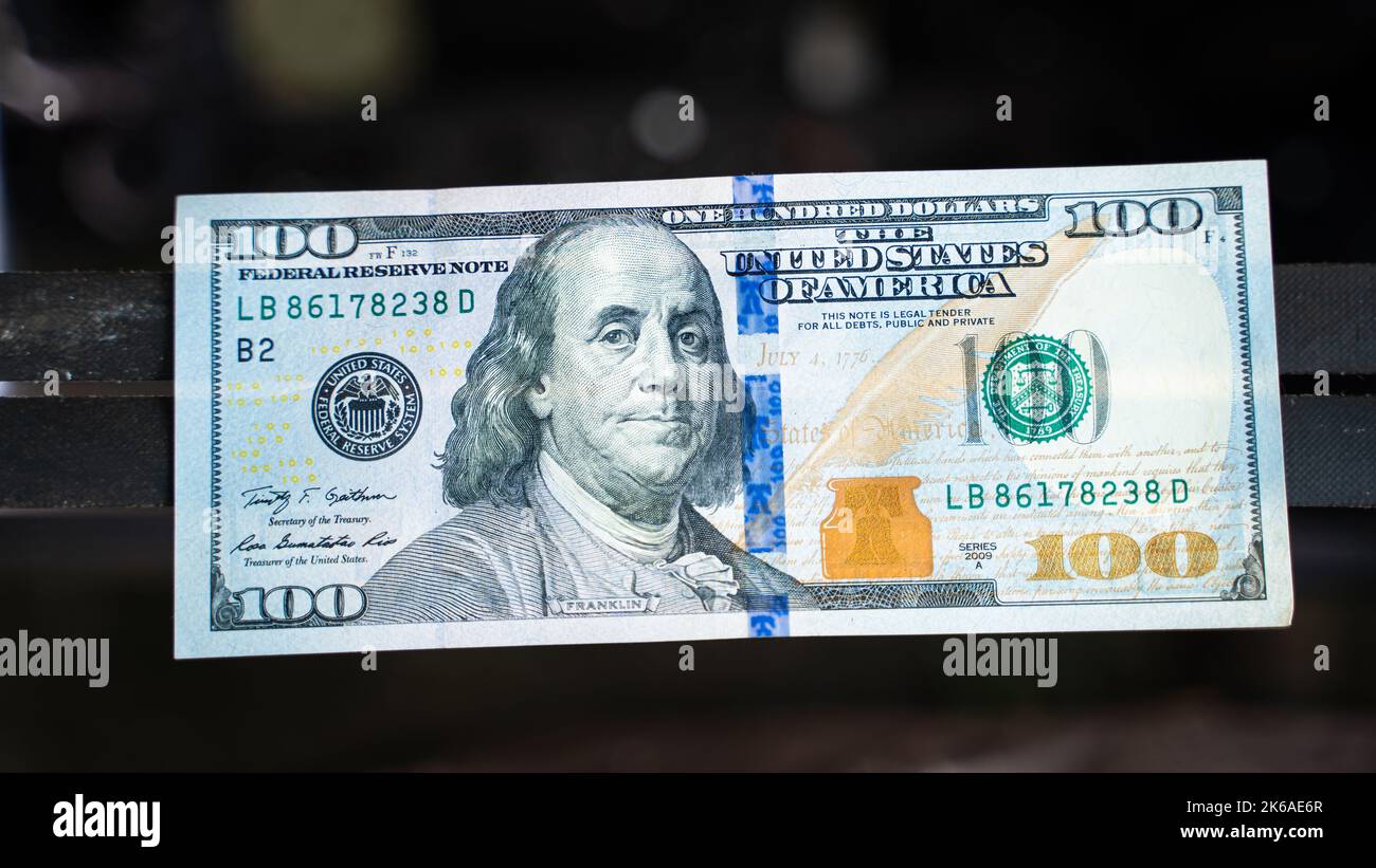 One hundred dollar bill close-up on a dark background. Money on the ...