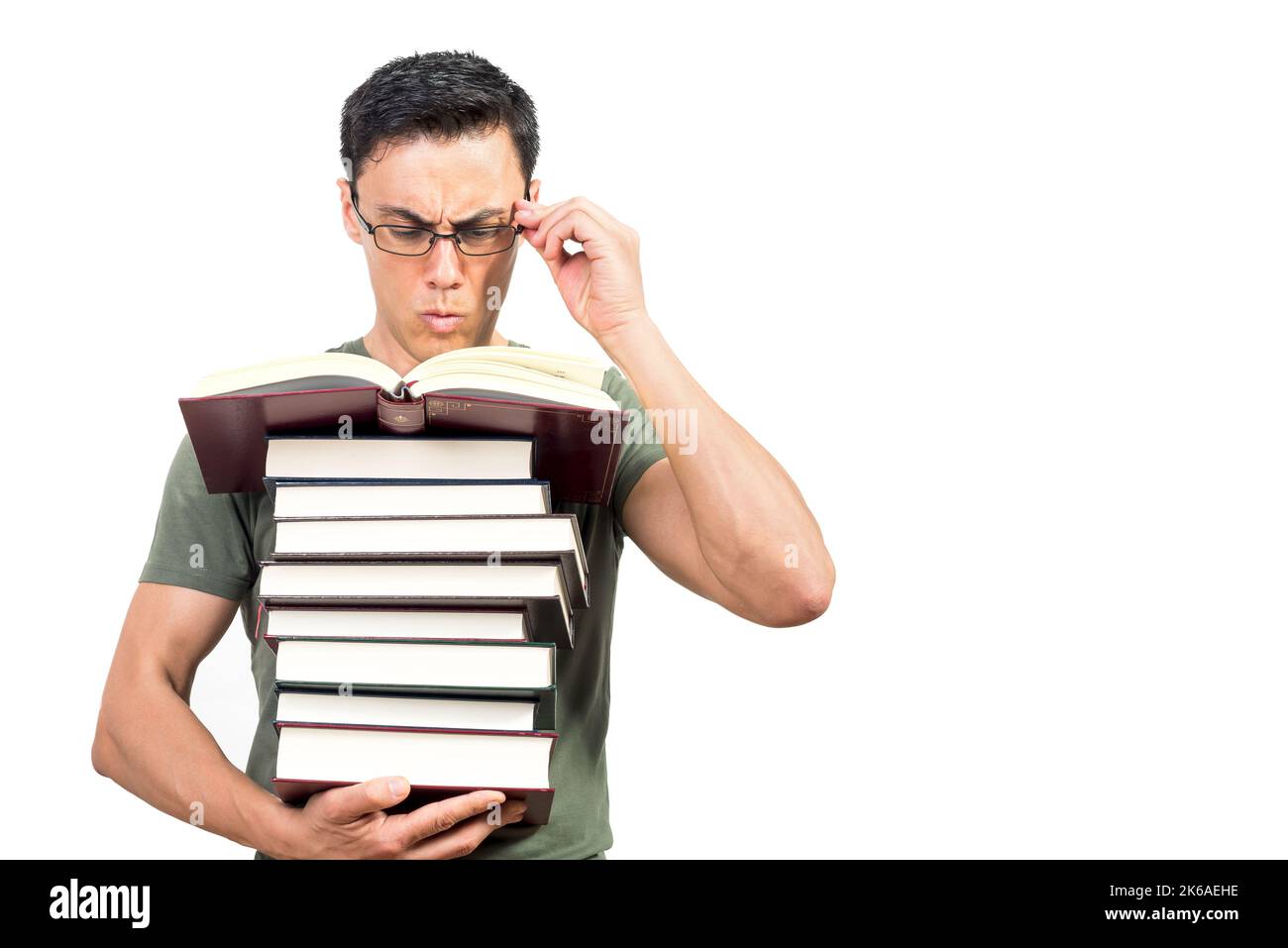 Smart man adjusting glasses and reading book Stock Photo - Alamy