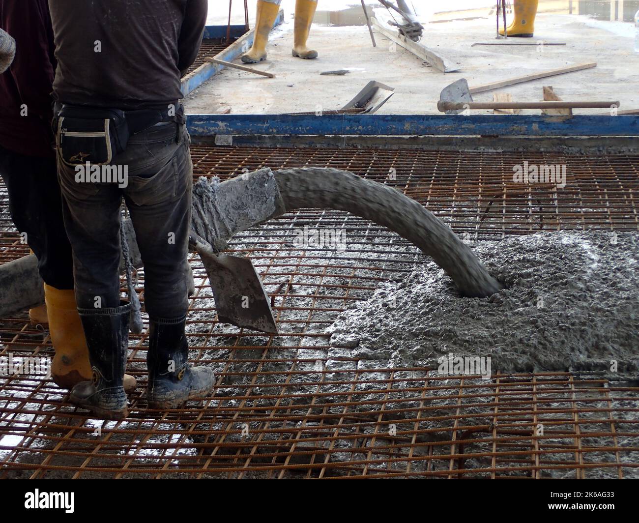 Construction worker pouring concrete for a building floor slab Stock ...