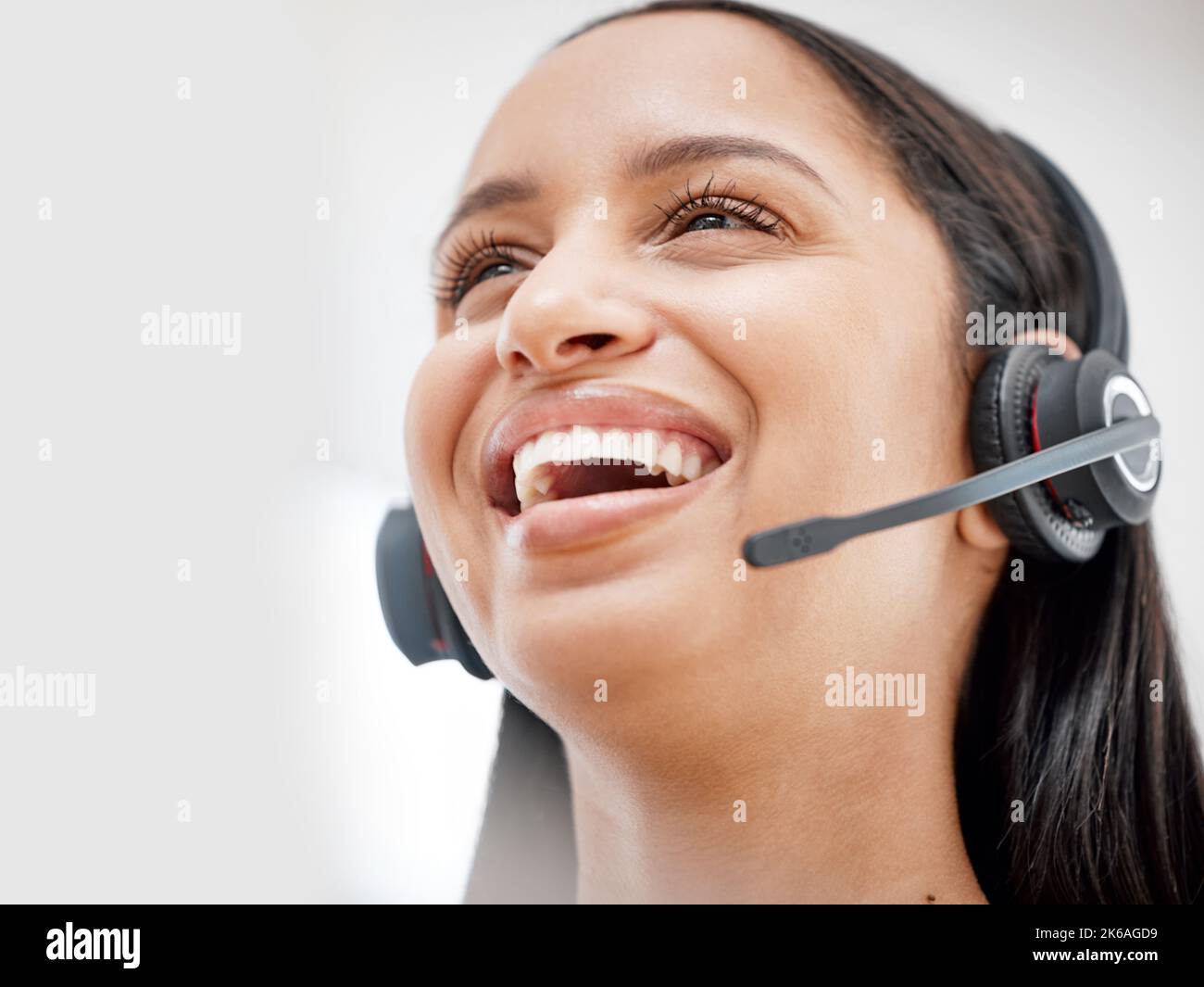 One young hispanic happy and cheerful female call center agent wearing a headset and working in ...