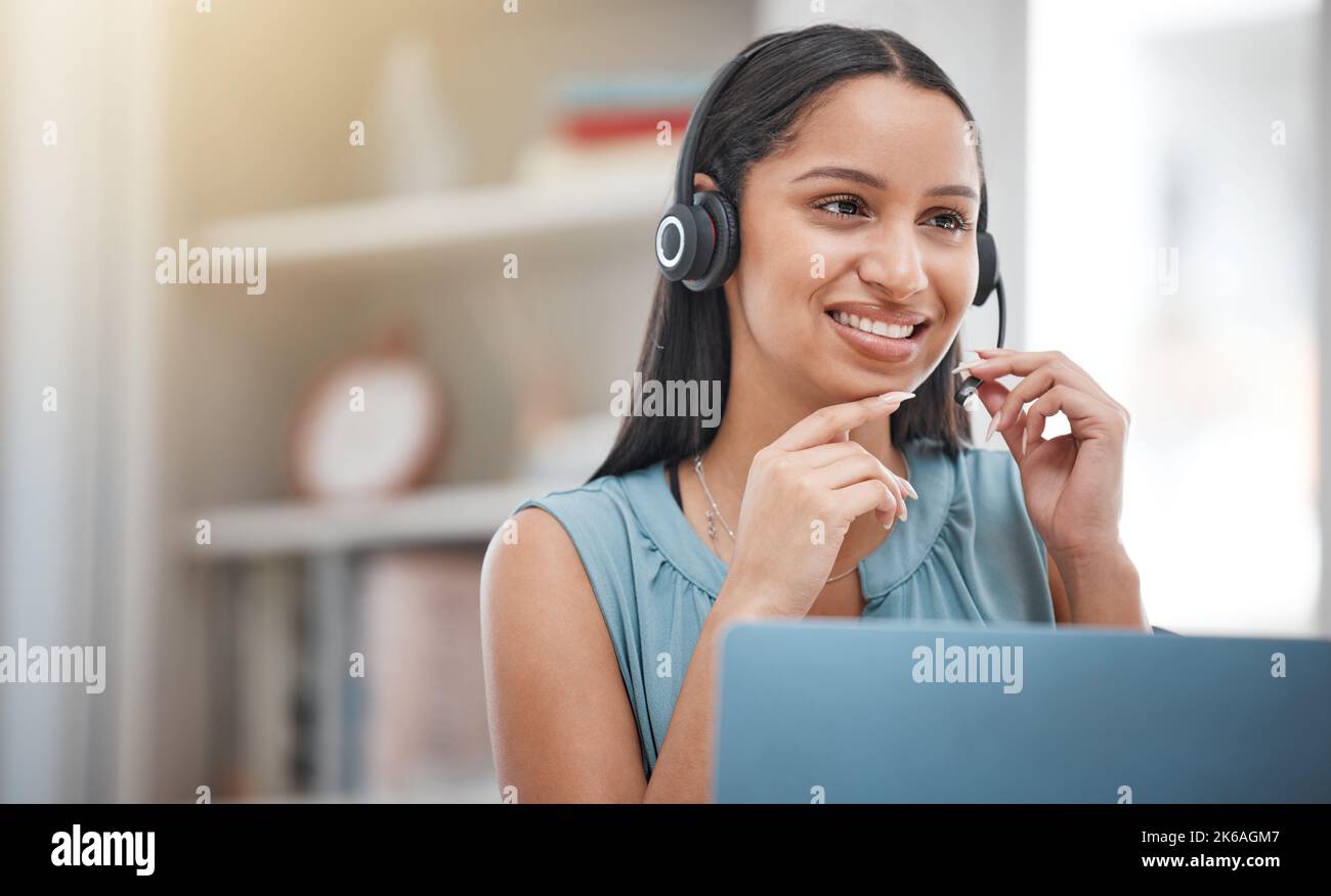 One young hispanic happy and cheerful female call center agent wearing a headset and working in ...