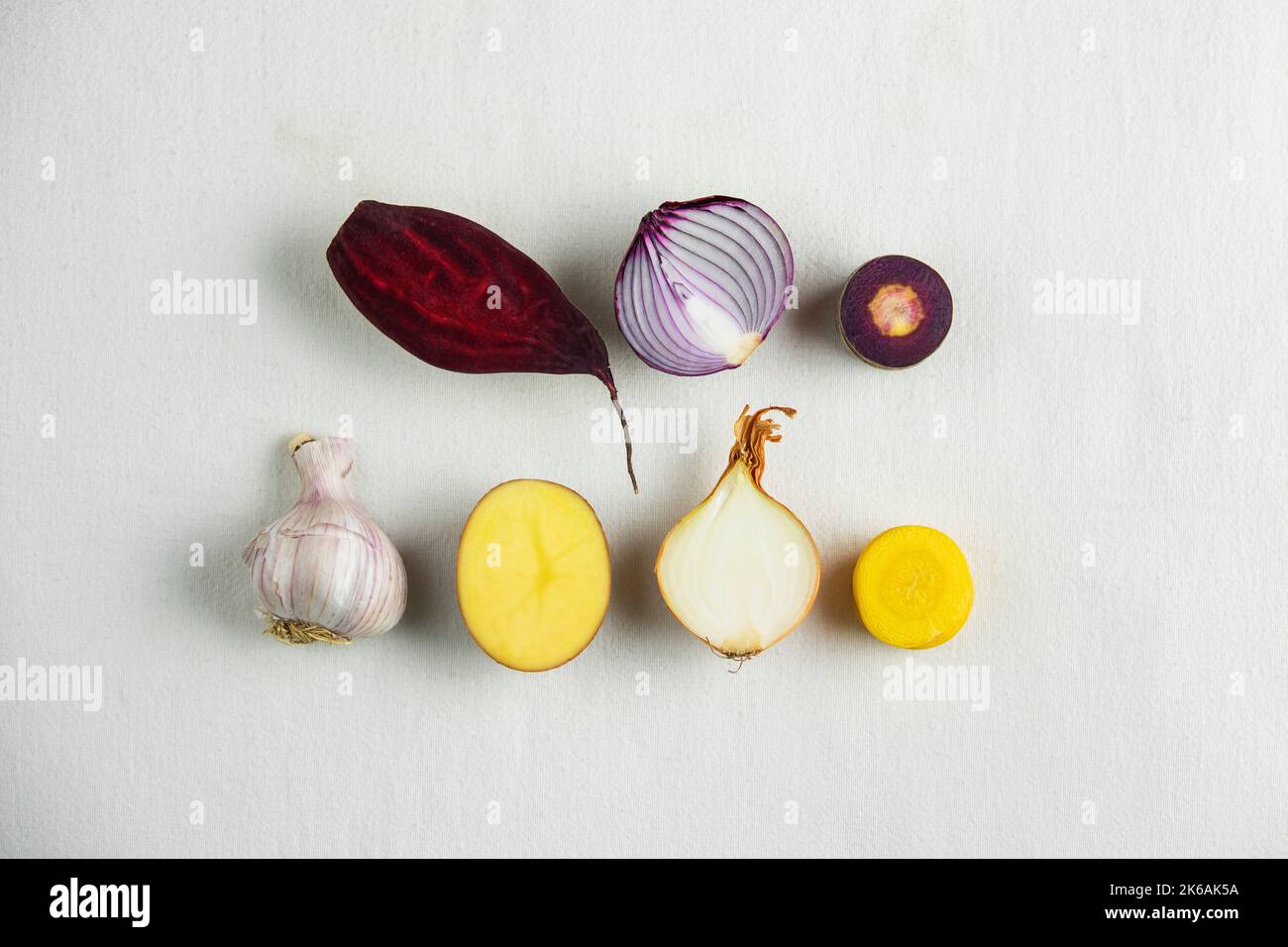 A closeup of different types of cutted vegetables in white background ...