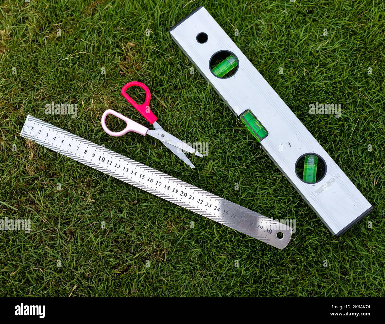 Tools for cutting the grass perfectly and smooth Stock Photo - Alamy