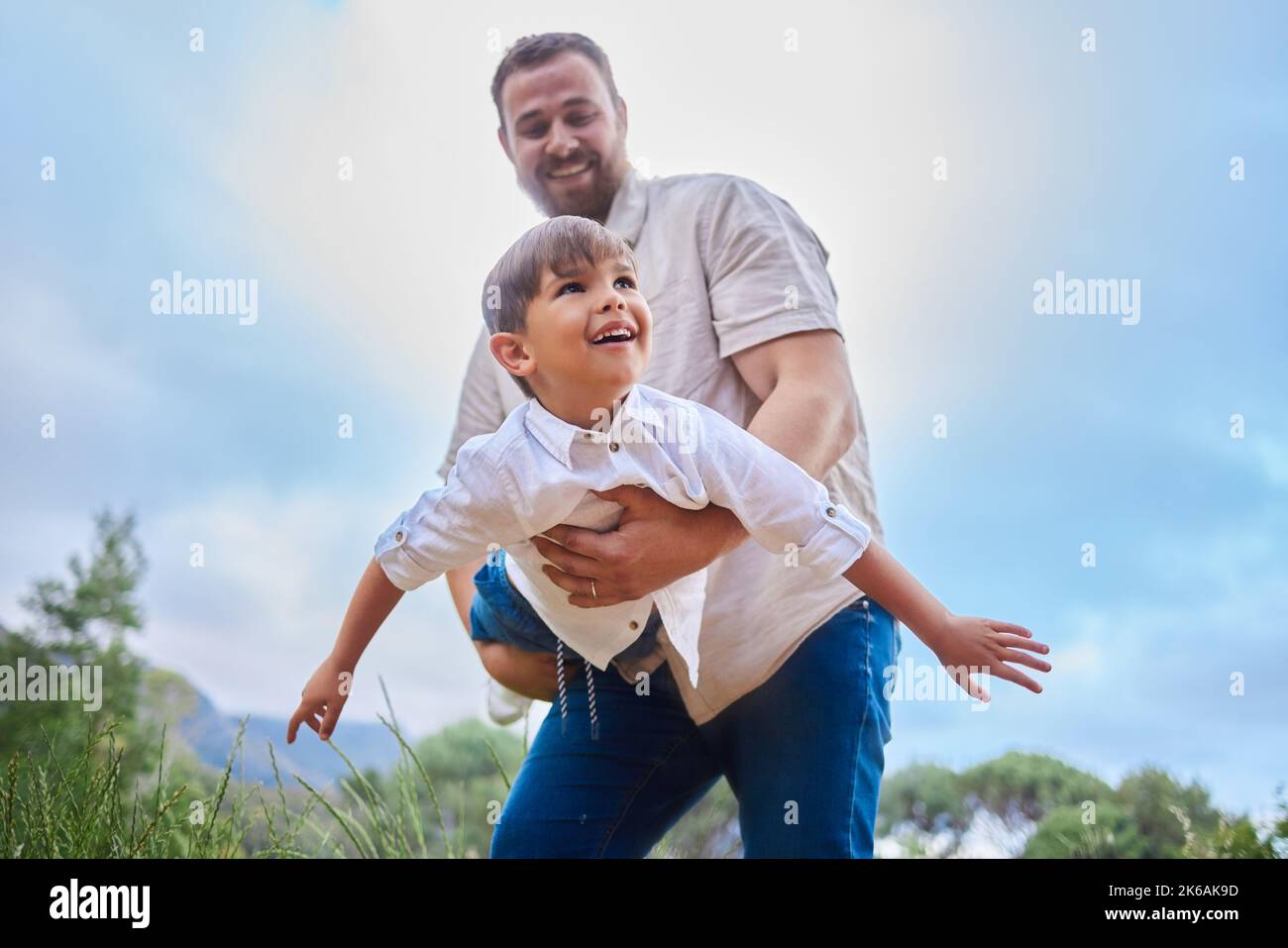 Reach for your dreams. a young father and son spending time together ...