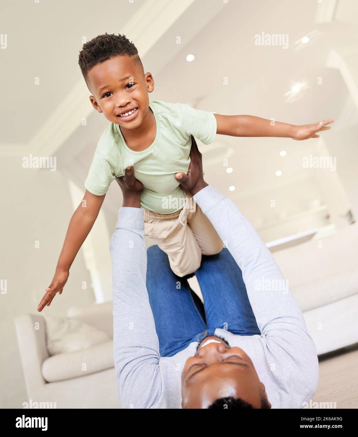 Little african american boy playing and having fun with father while ...