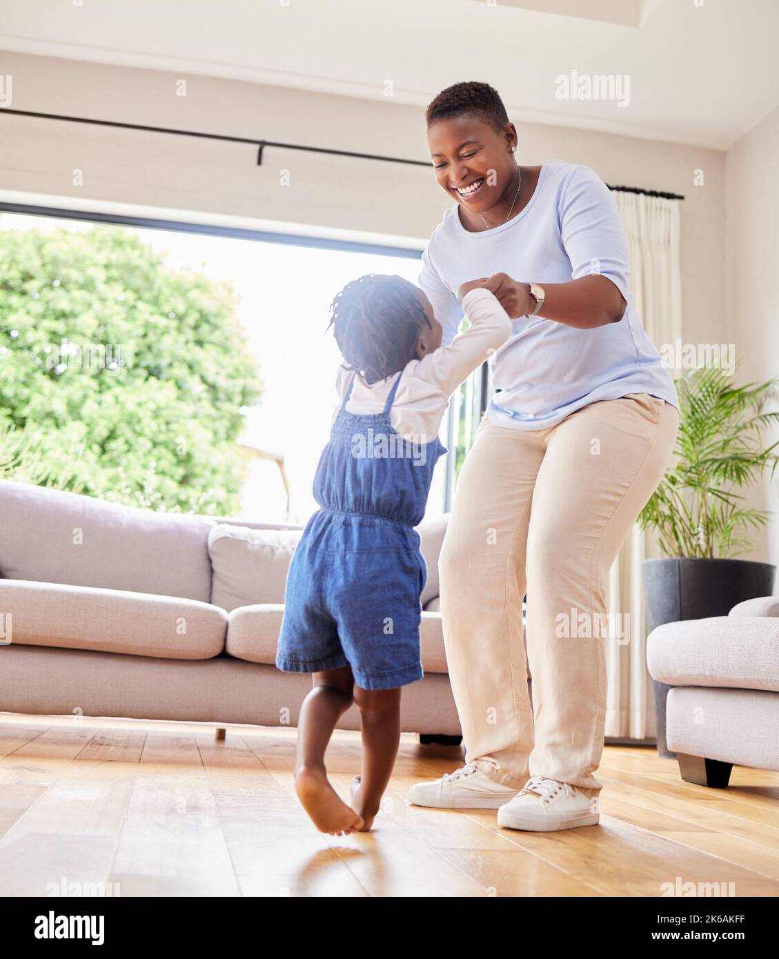 Showing off her moves. a mother and daughter dancing in the lounge at ...