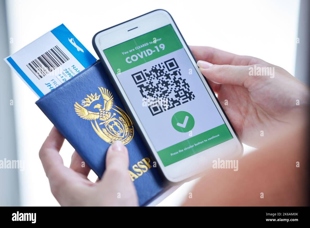 Passport, travel and covid vaccine phone QR barcode of hands holding ...