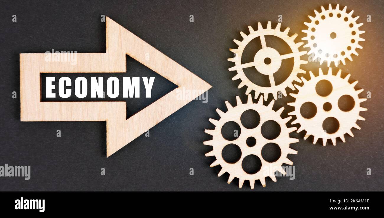 Business and finance concept. On a black background, gears and an arrow ...
