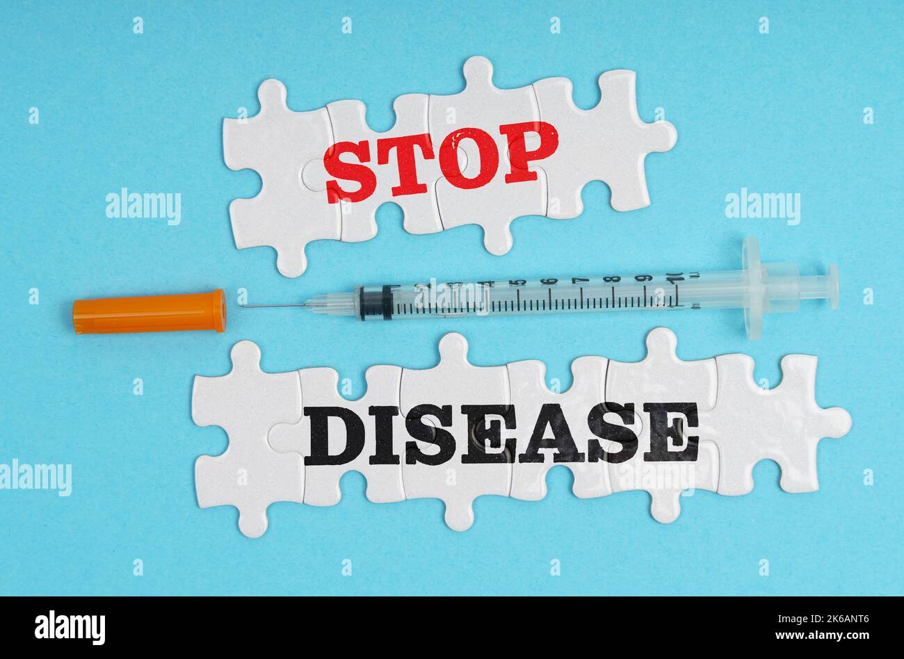 Medicine concept. On a blue background, a syringe and puzzles with the ...