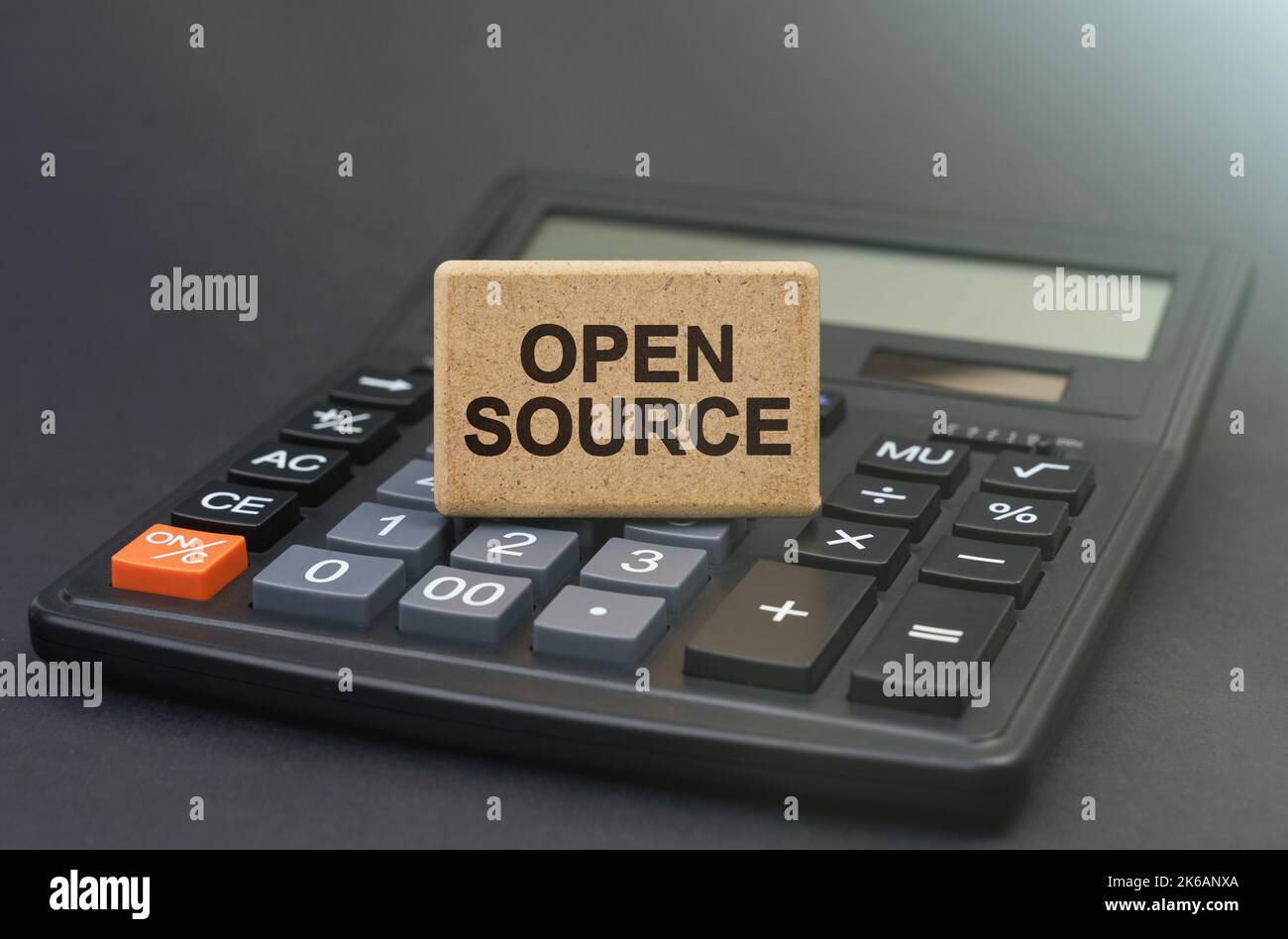 Business concept. There is a sign on the calculator that says - Open ...