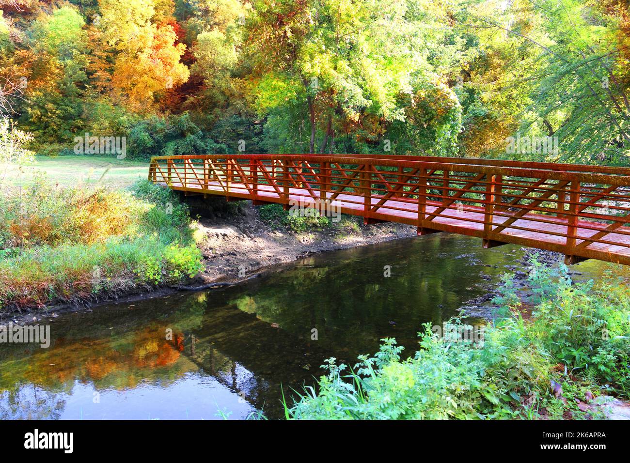 a red rusted footbridge walkway bridge national park nature reserve ...