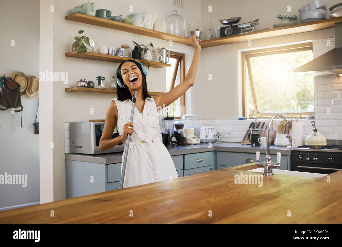 Cleaning, headphones and black woman, dancing, singing with music in ...