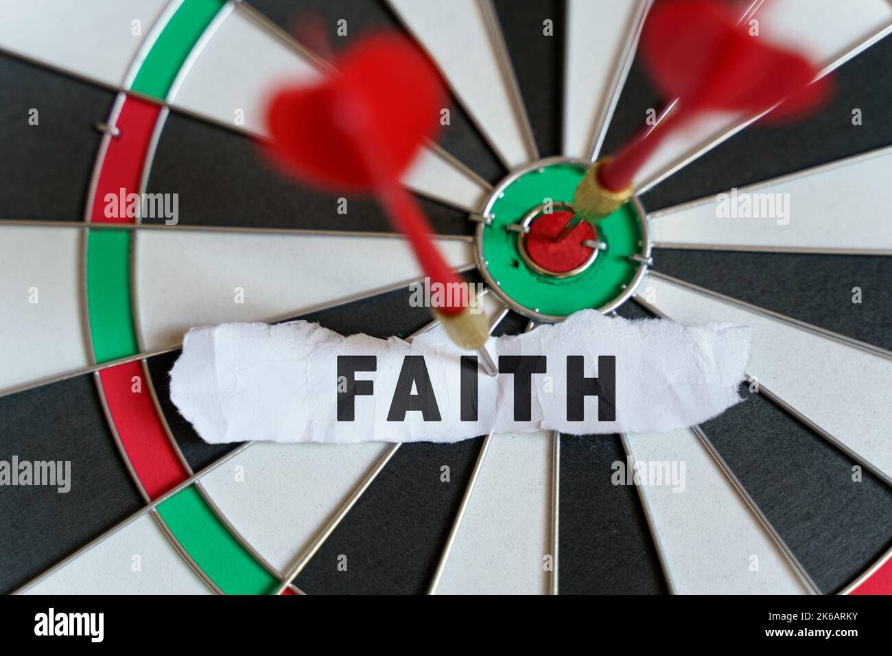 Target. The picture shows a target, darts and a torn piece of paper ...