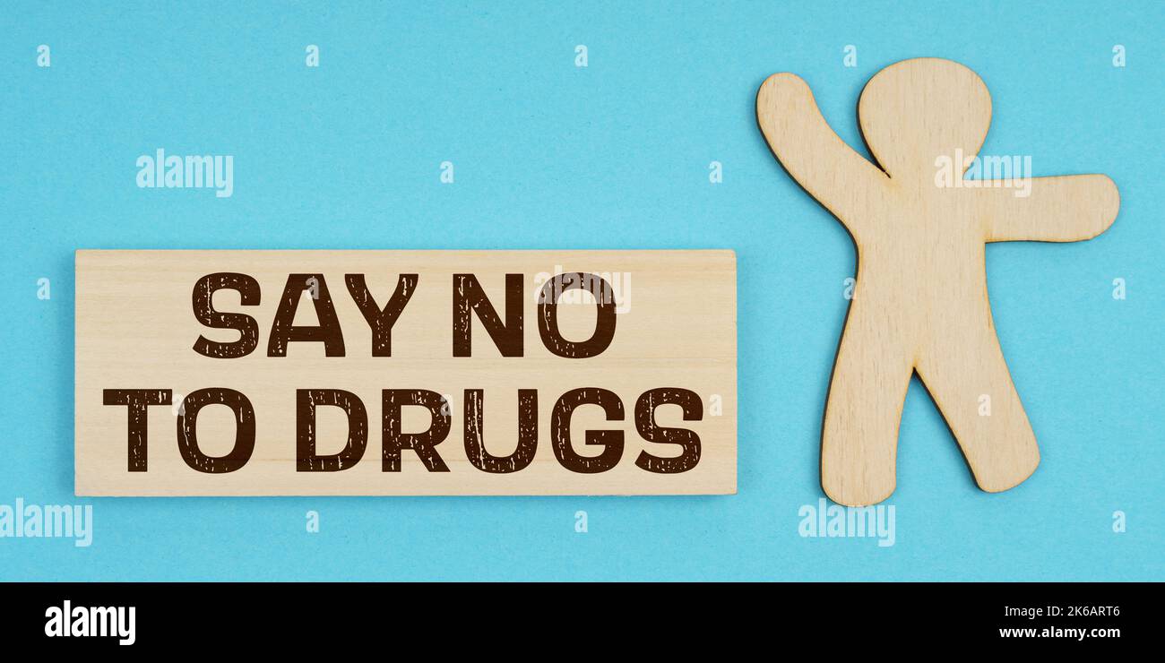 Medicine concept. On a blue background, a wooden figure of a man and a ...