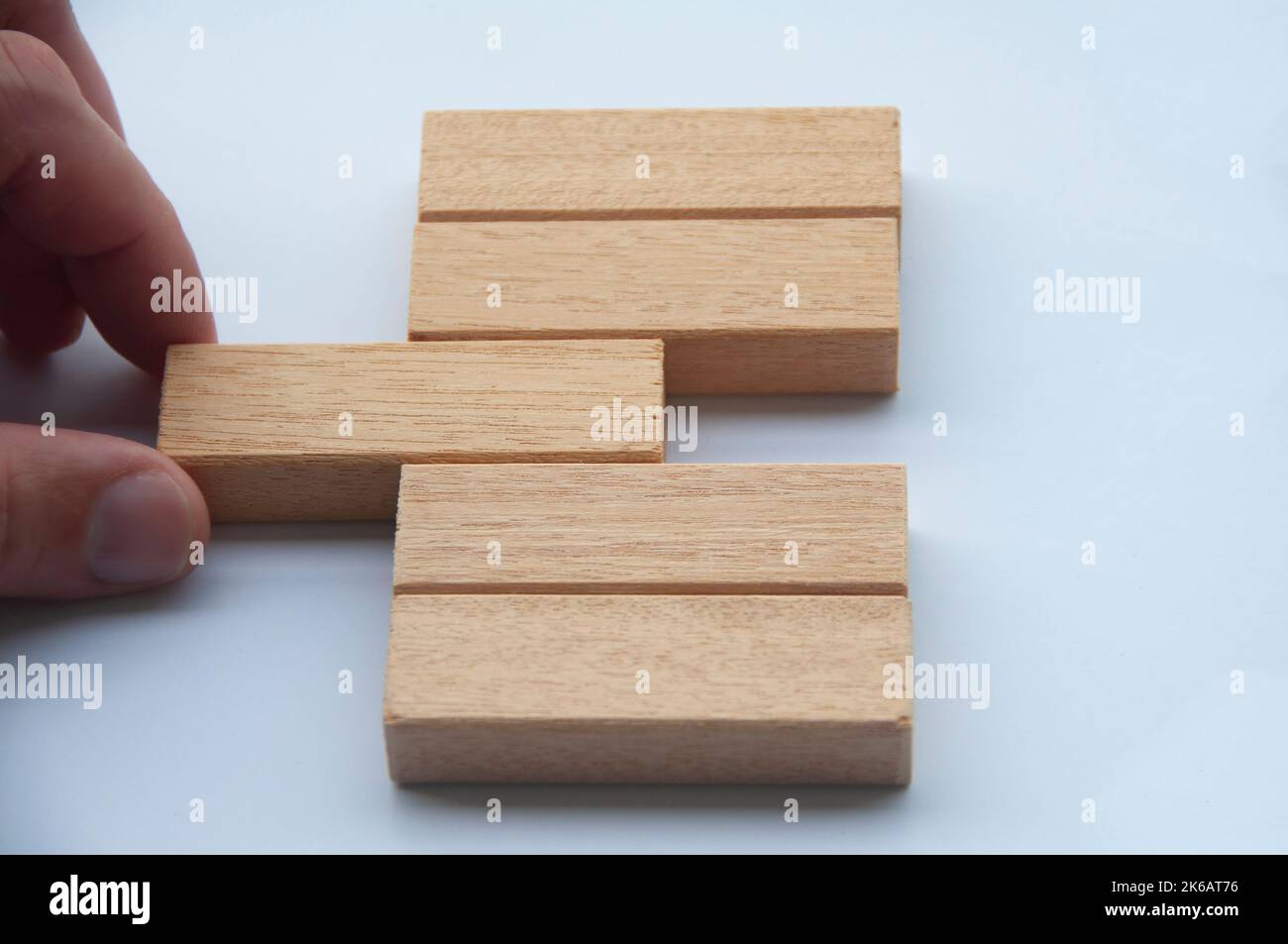 hand placing a wooden block with customizable space for text or ideas ...