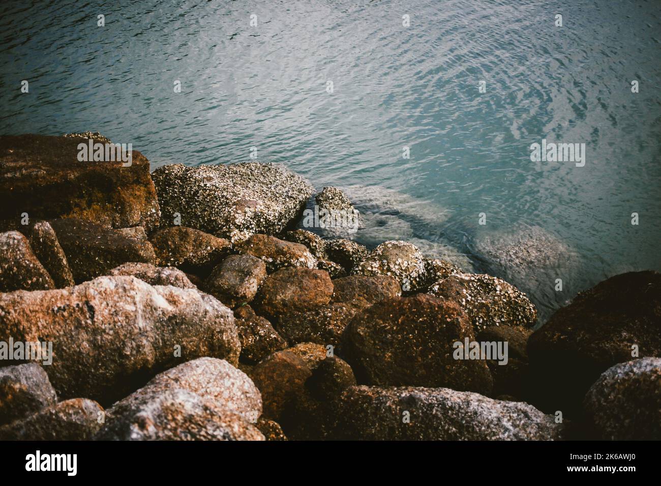 Rocky beach landscape at dusk Stock Photo - Alamy