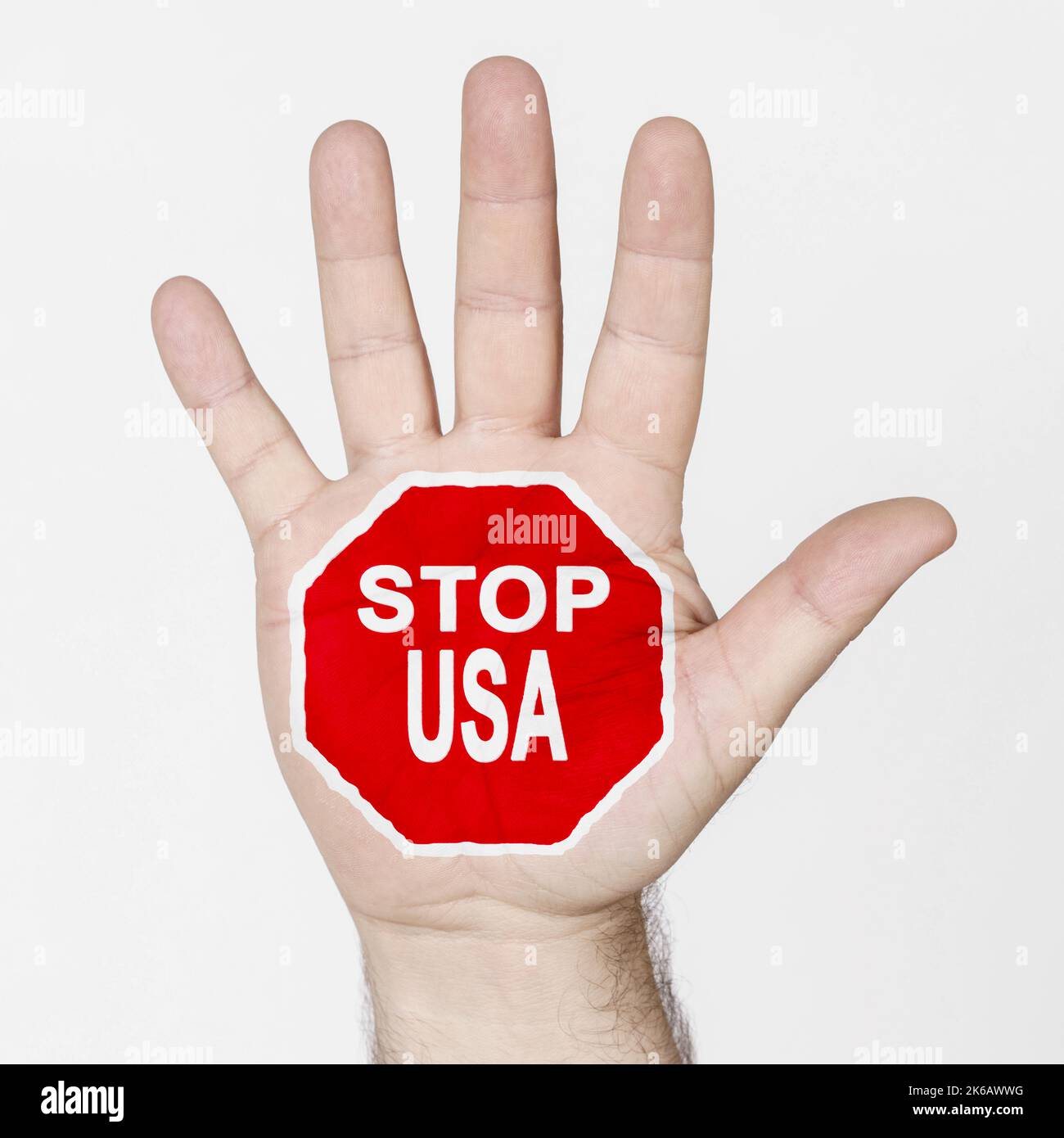 On the palm of the hand there is a stop sign with the inscription ...
