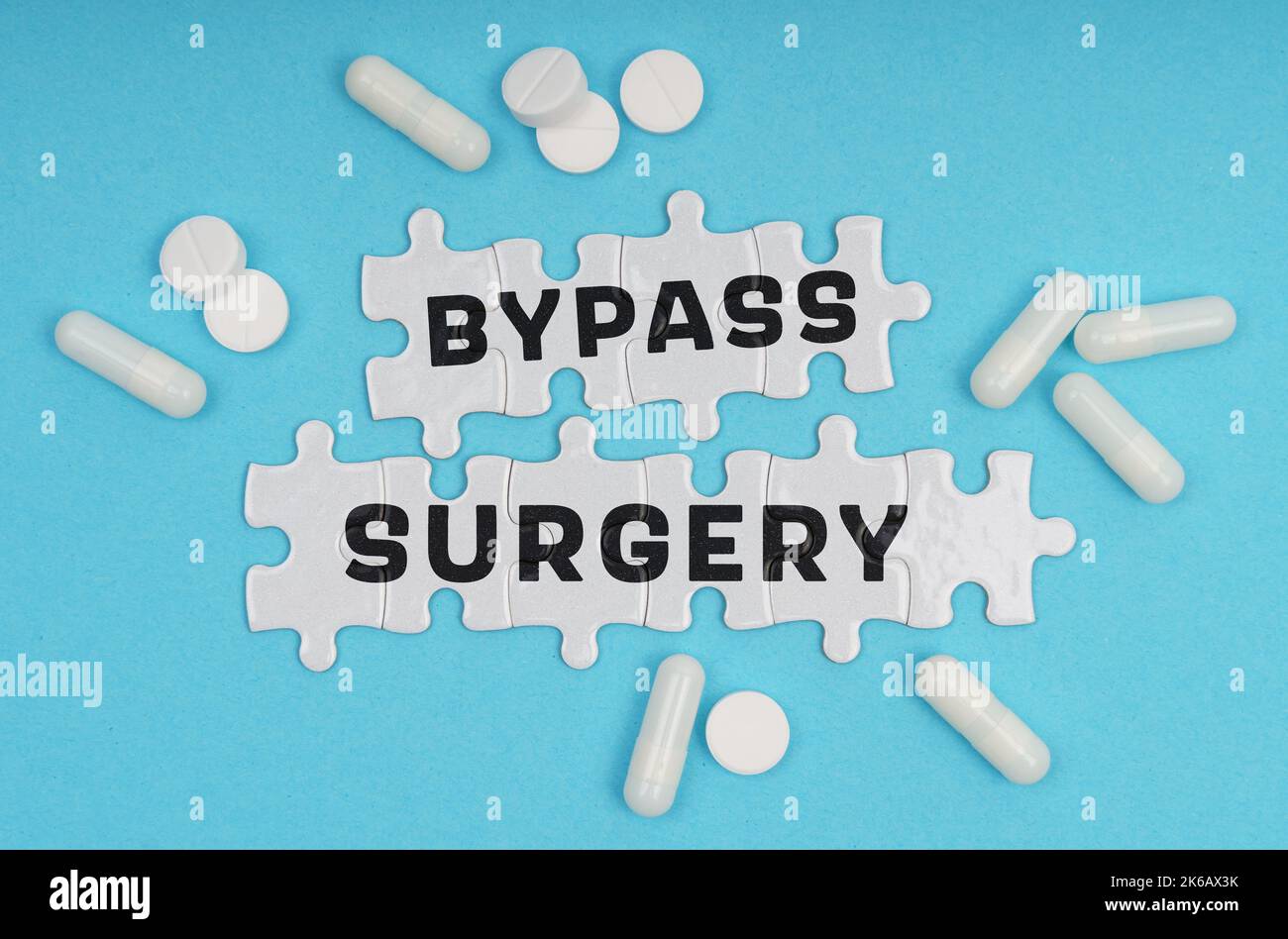 Medicine concept. On a blue background pills and puzzles with the ...