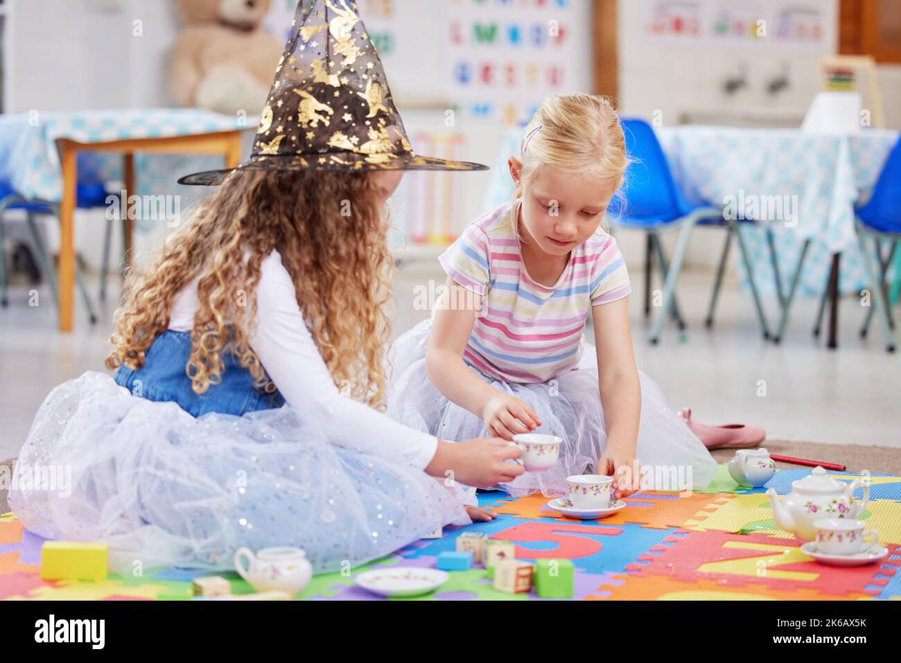 All dressed up for a tea party. two girls playing together in class ...