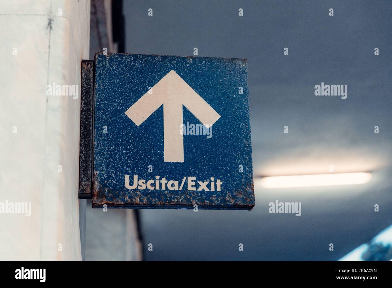 An 'exit' sign with narrow showing up Stock Photo - Alamy