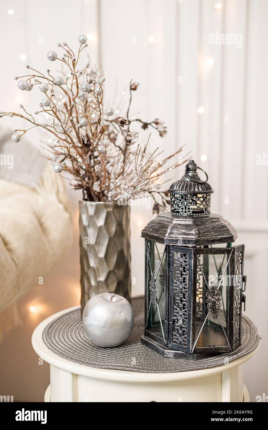 Decorative antique silver retro lamp on a white small table in the ...