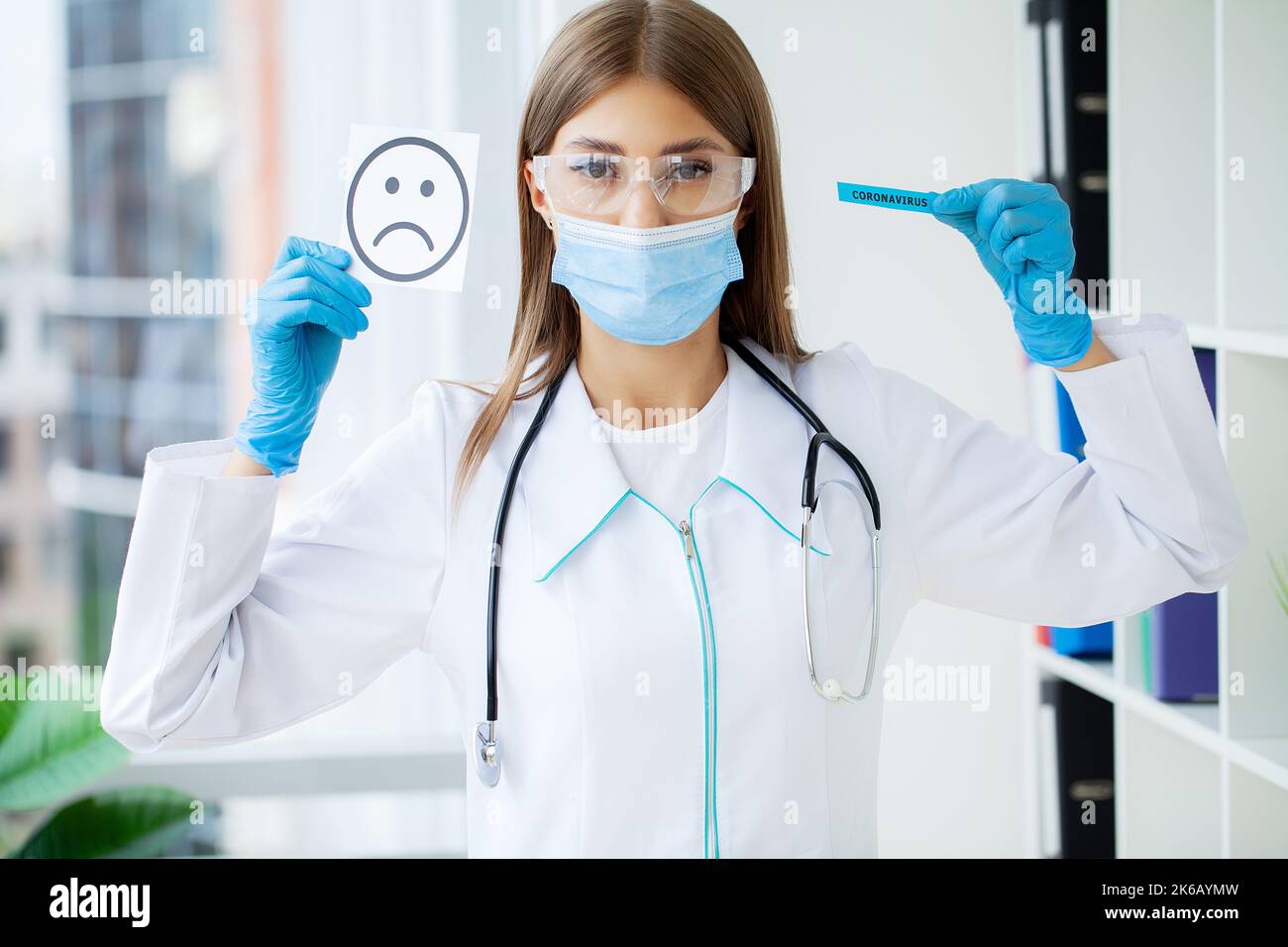 The doctor is holding a card with the Sad Smile symbol in the office of ...