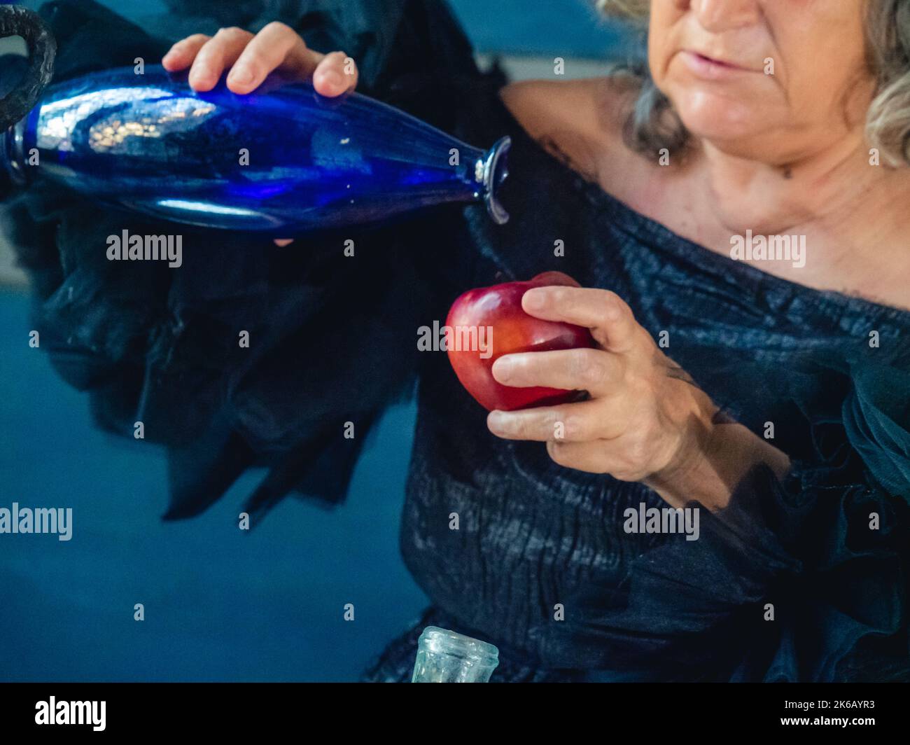 witchy preparing poisoned apple for victim as dark evil spell for ...