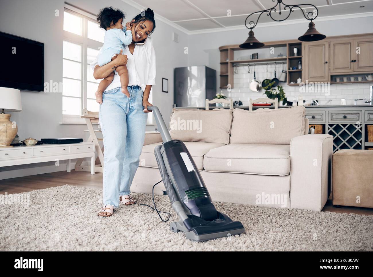 She manages, somehow. a young mother using a cellphone while completing ...