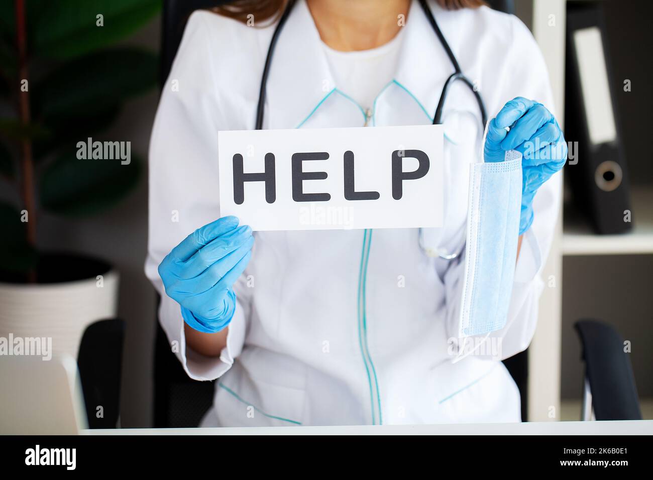 Medical doctor or nurse showing help sign Stock Photo - Alamy