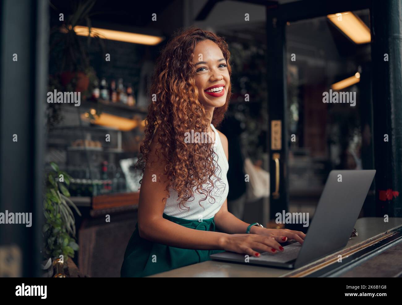African woman, laptop and remote work at restaurant writing novel ...
