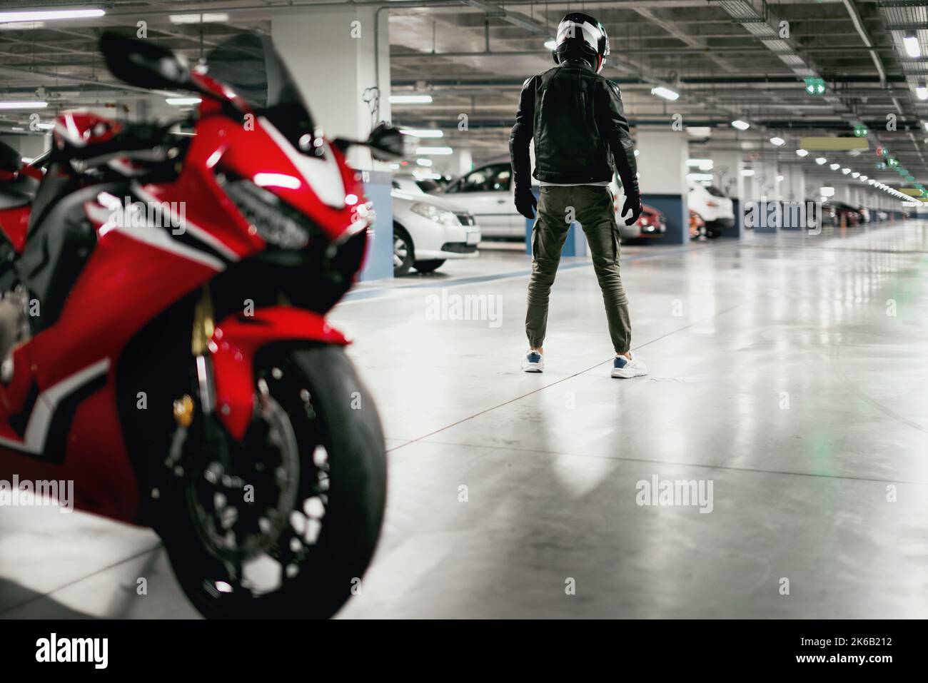 Back view of a motorcycle rider with a helmet and defocused race ...